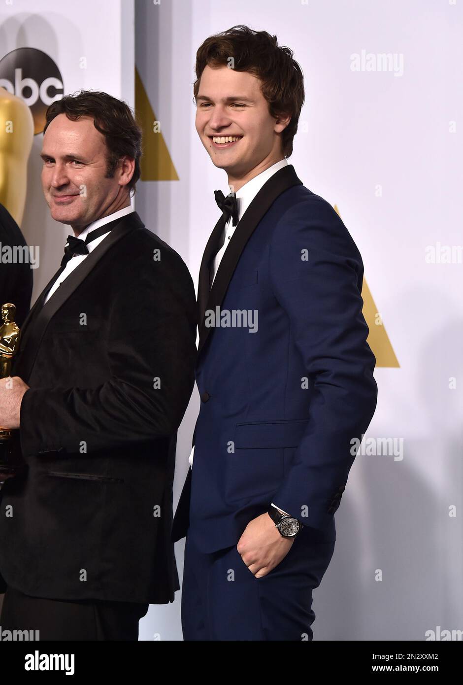 Scott Fisher, left, and Ansel Elgort pose in the press room with the ...