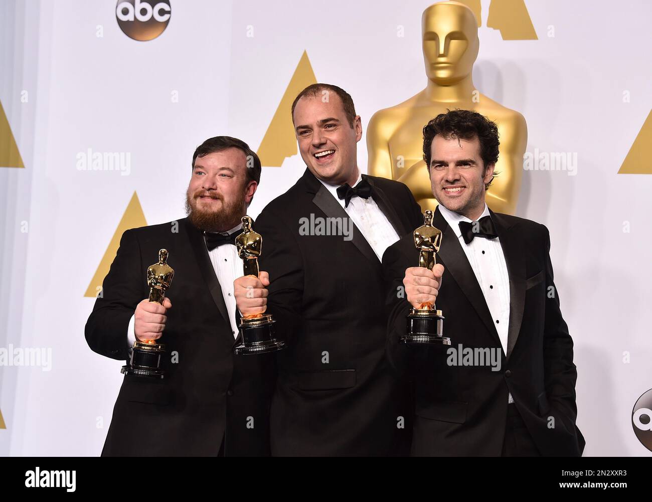 Thomas Curley, and from left, Ben Wilkins and Craig Mann pose in the press room with the award ...