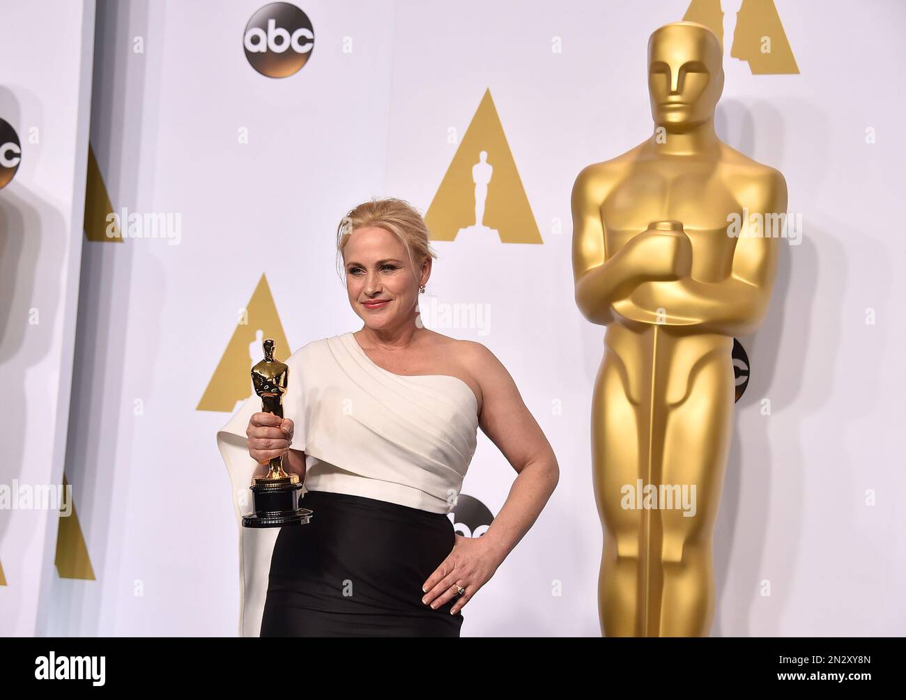 Patricia Arquette poses in the press room with the award for best ...