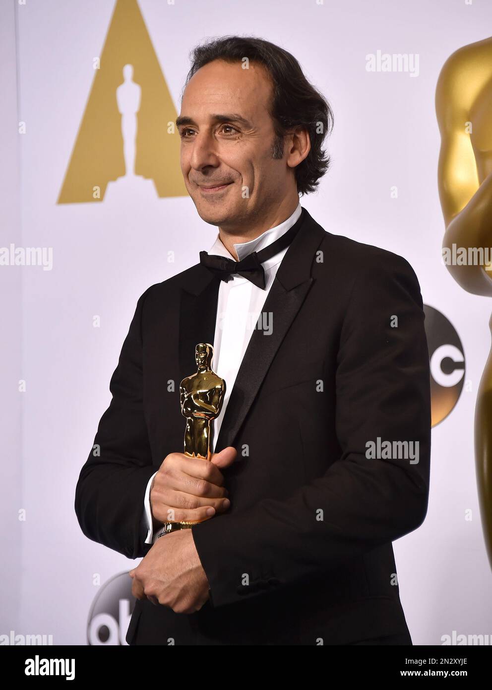 Alexandre Desplat poses in the press room with the award for best ...