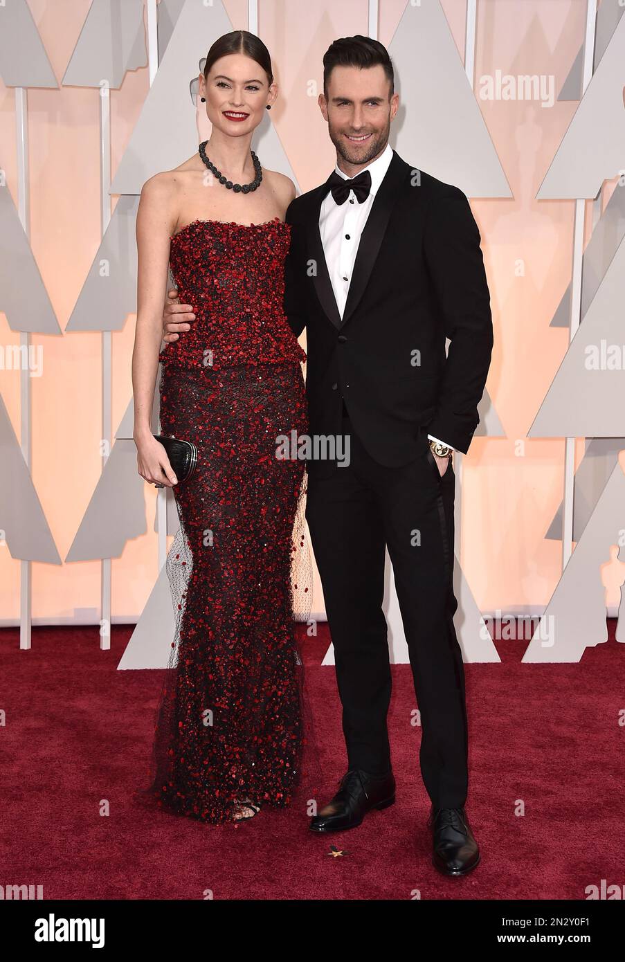 Behati Prinsloo, left, and Adam Levine arrive at the Oscars on Sunday ...