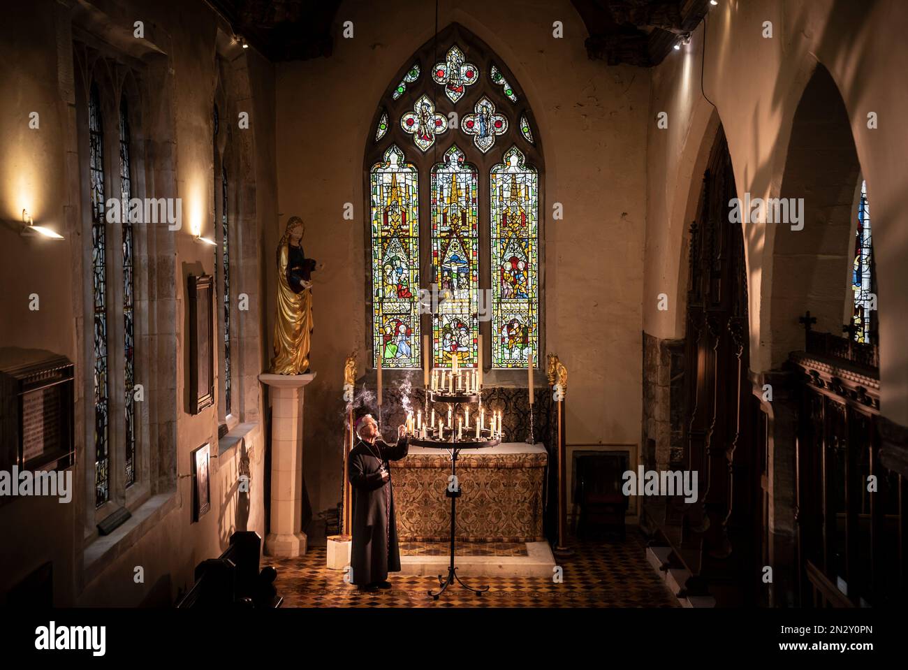 The Rt Reverend Glyn Webster lights a candle in front of the newly ...