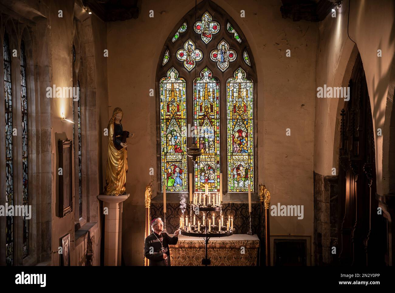 The Rt Reverend Glyn Webster lights a candle in front of the newly ...
