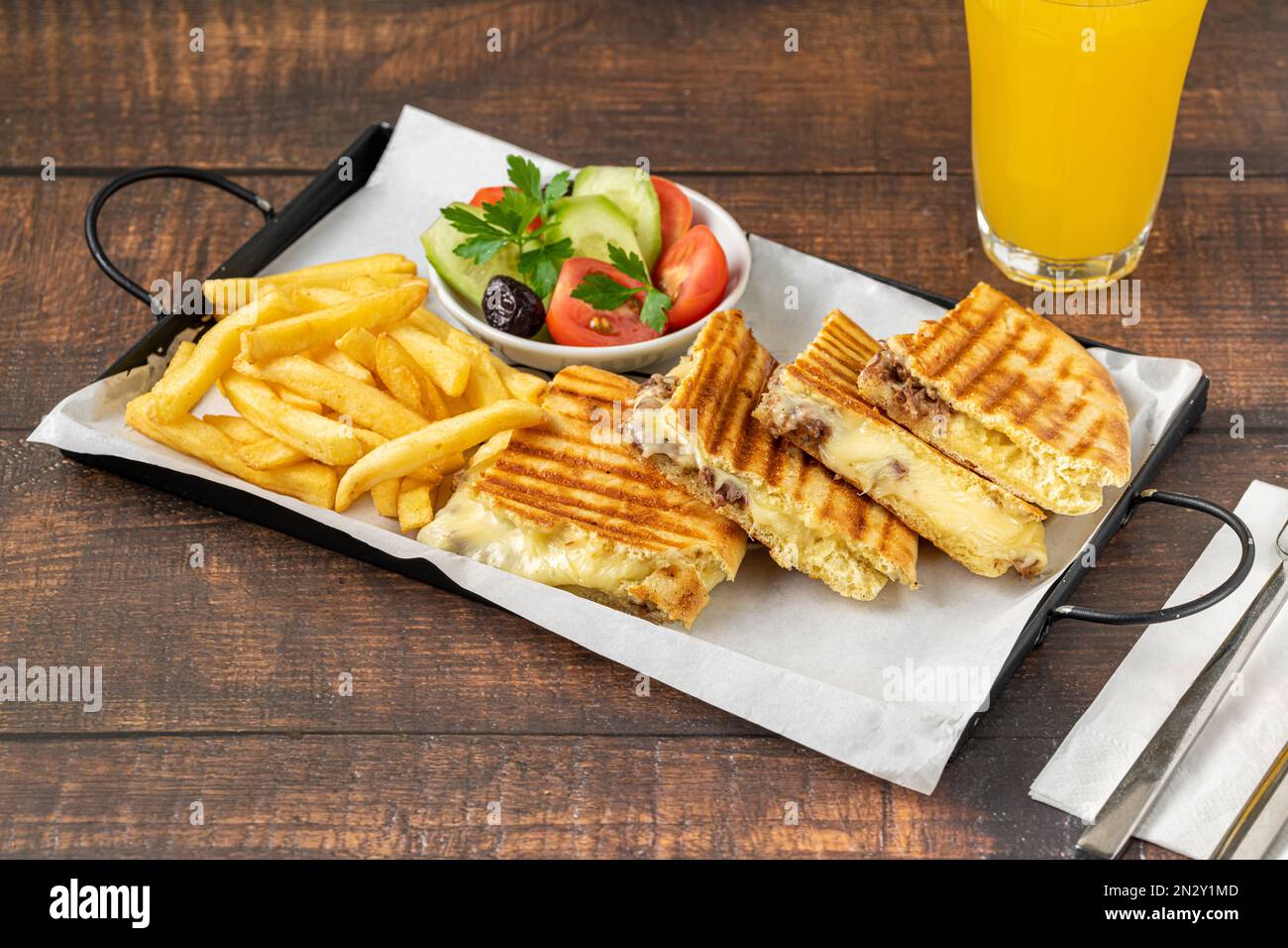 Turkish toast with roasted meat served with olives, cucumbers and ...