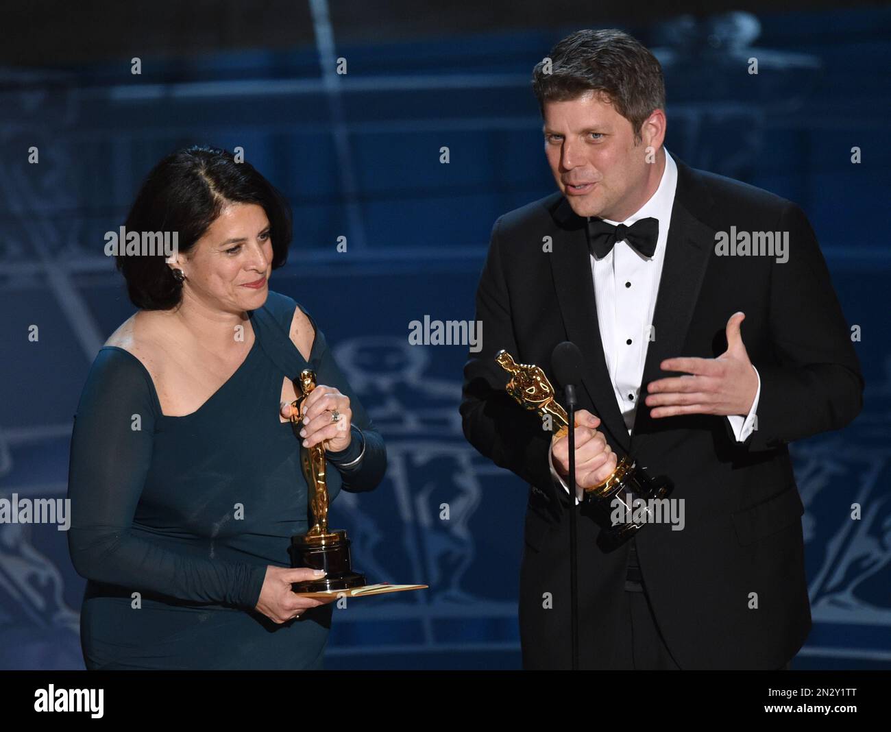 Anna Pinnock, left, and Adam Stockhausen accept the award for best ...
