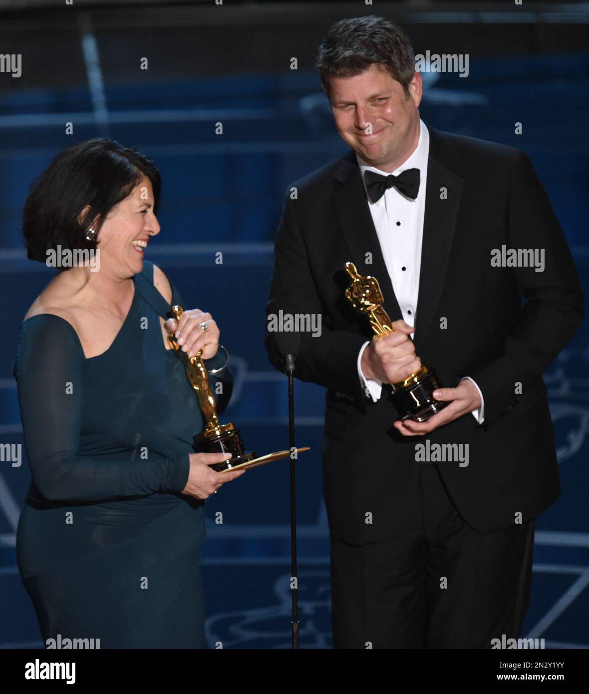 Anna Pinnock, left, and Adam Stockhausen accept the award for best ...