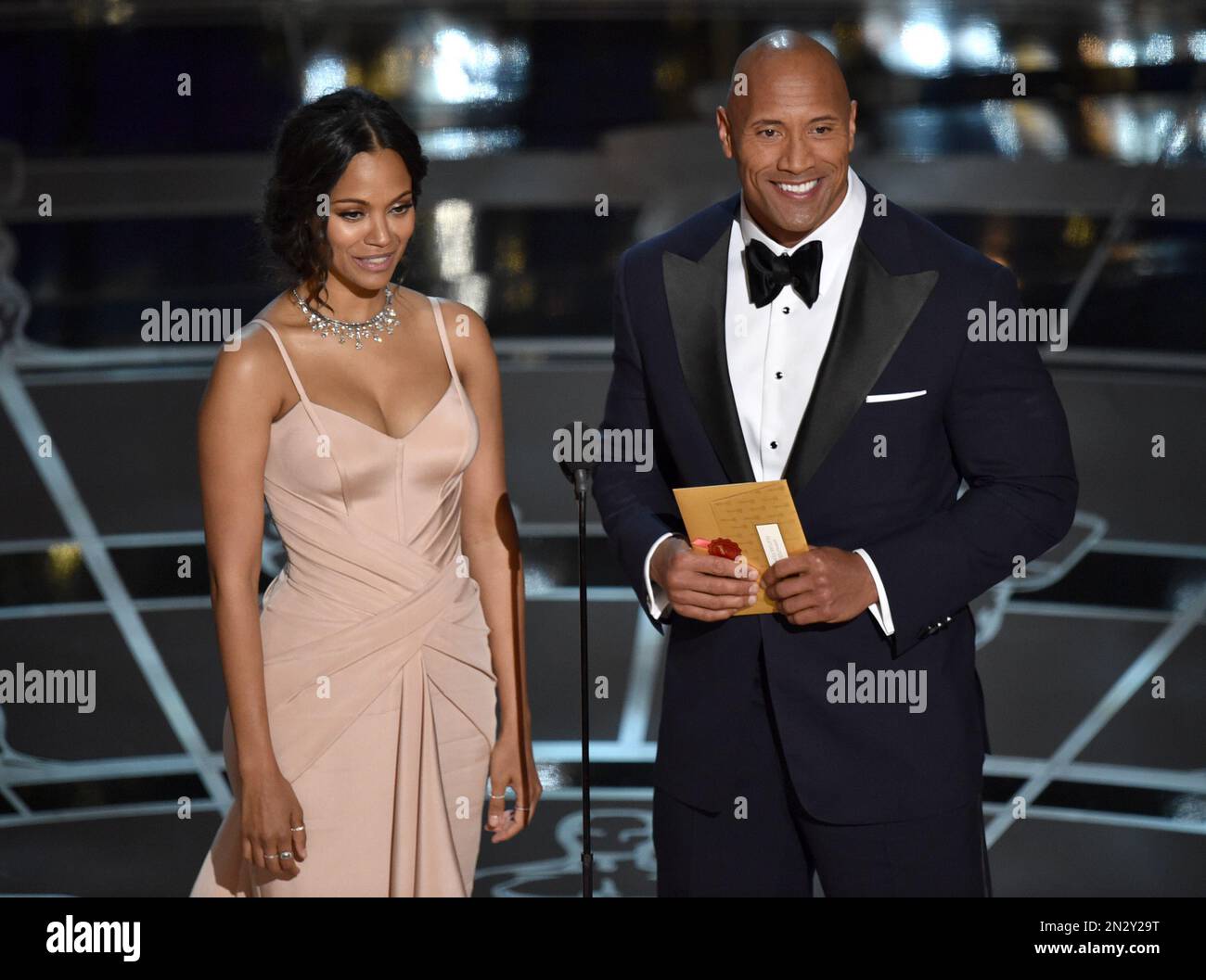 Zoe Saldana, left, and Dwayne Johnson present the award for best ...