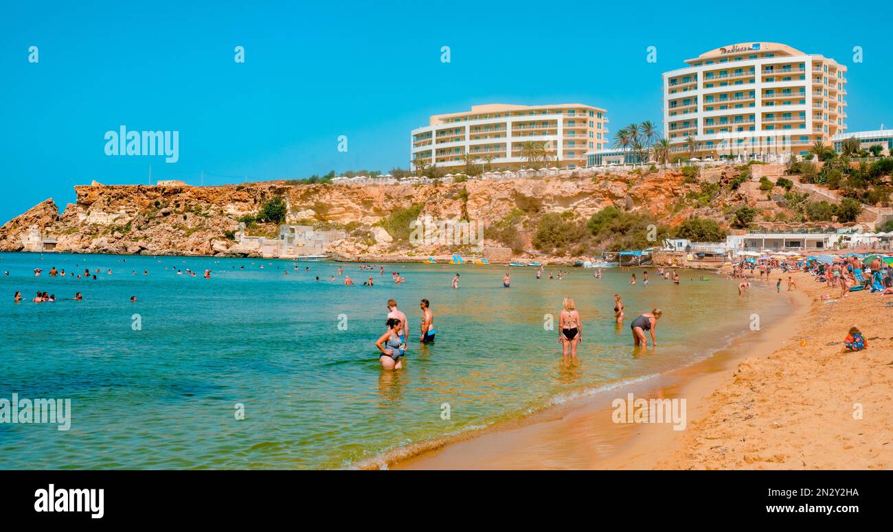 Mellieha, Malta - September 5, 2022: Some people stands in the water in ...