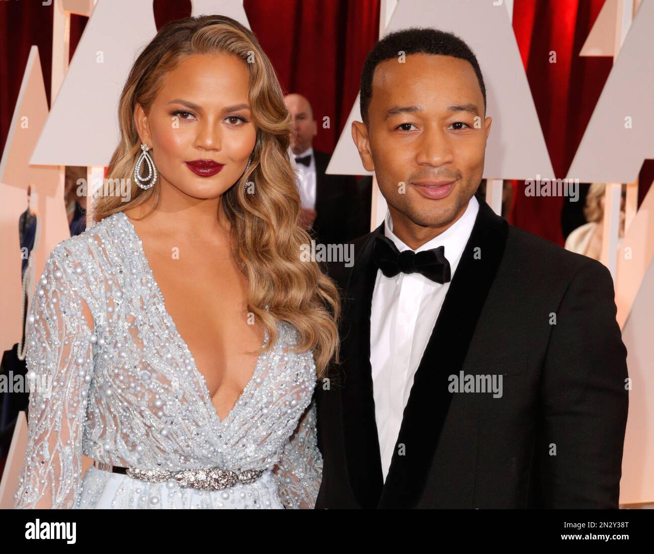 Chrissy Teigen, left, and John Legend arrives at the Oscars on Sunday ...