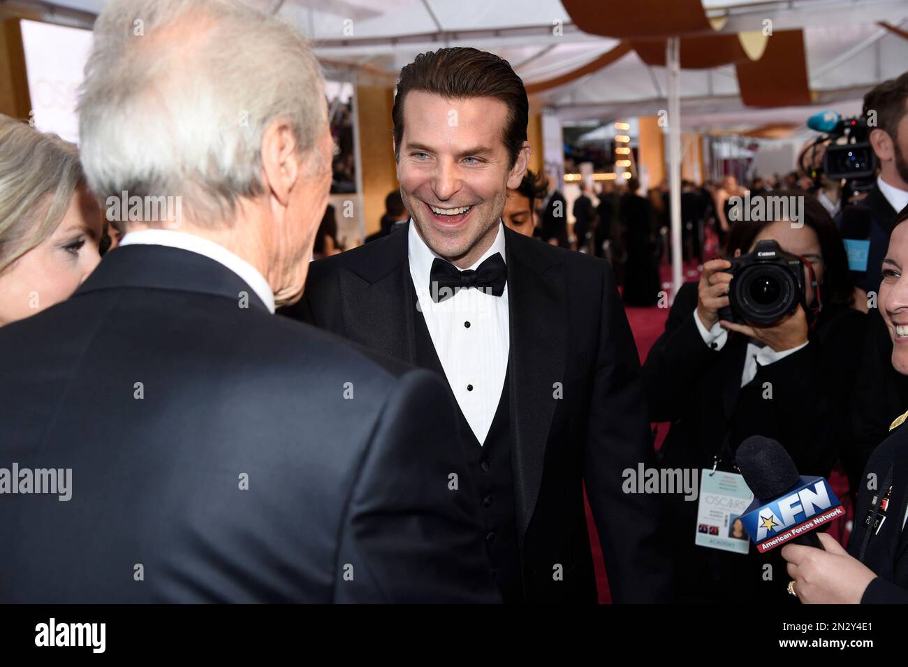 Clint Eastwood, left, and Bradley Cooper arrive at the Oscars on Sunday ...