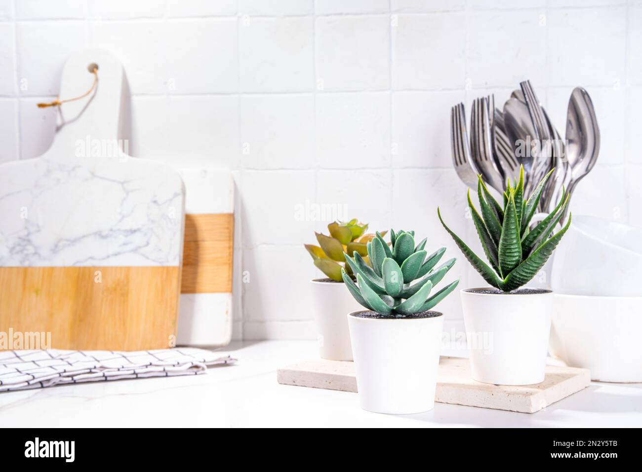 Home gardening, plants on kitchen corner. White pots with various ...