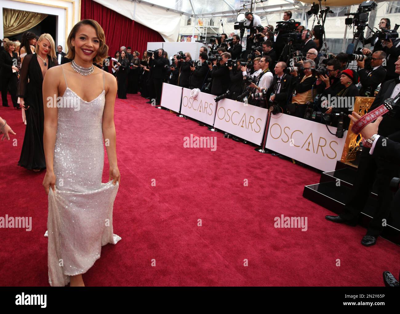 Margot Robbie, left, and Carmen Ejogo arrive at the Oscars on Sunday ...