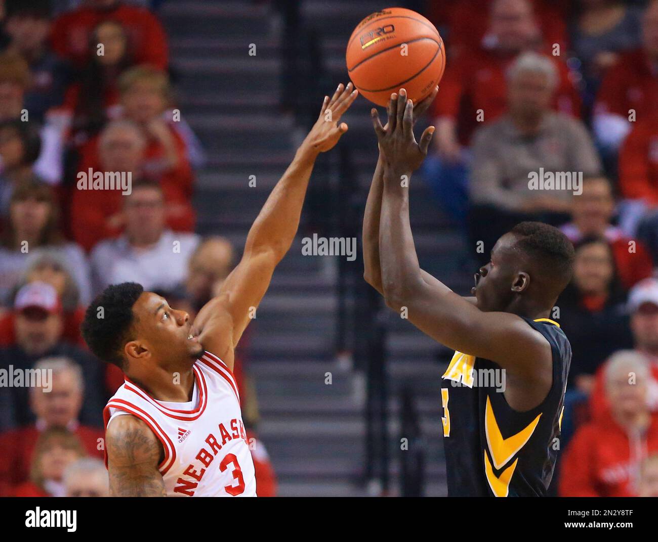 Iowa's Peter Jok, right, shoots over Nebraska's Benny Parker (3) during ...