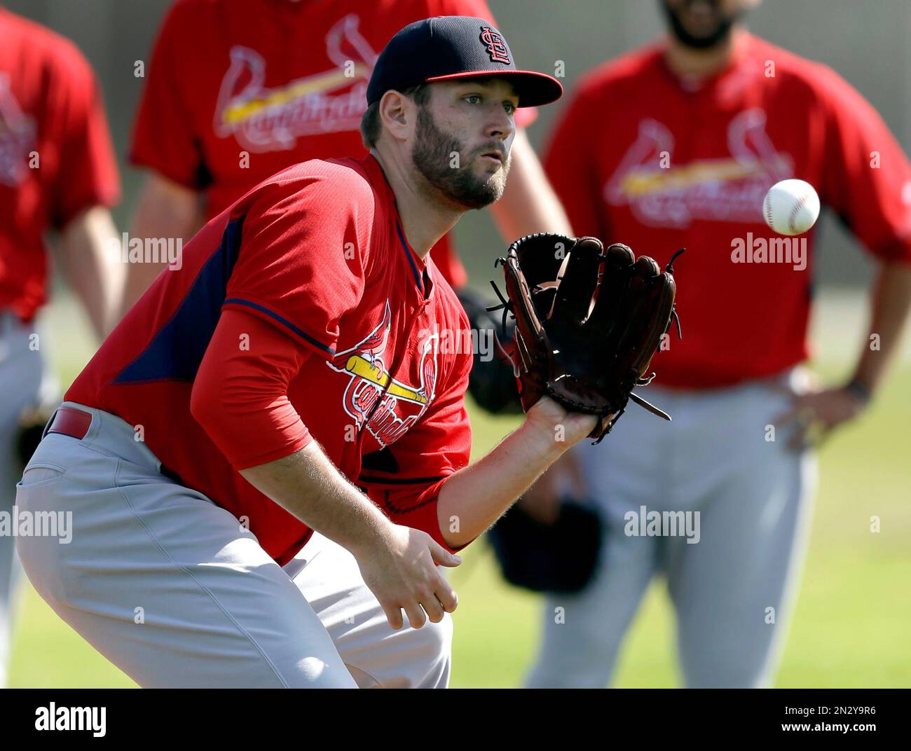 St. Louis Cardinals pitcher Lance Lynn stops a ball hit back to him ...