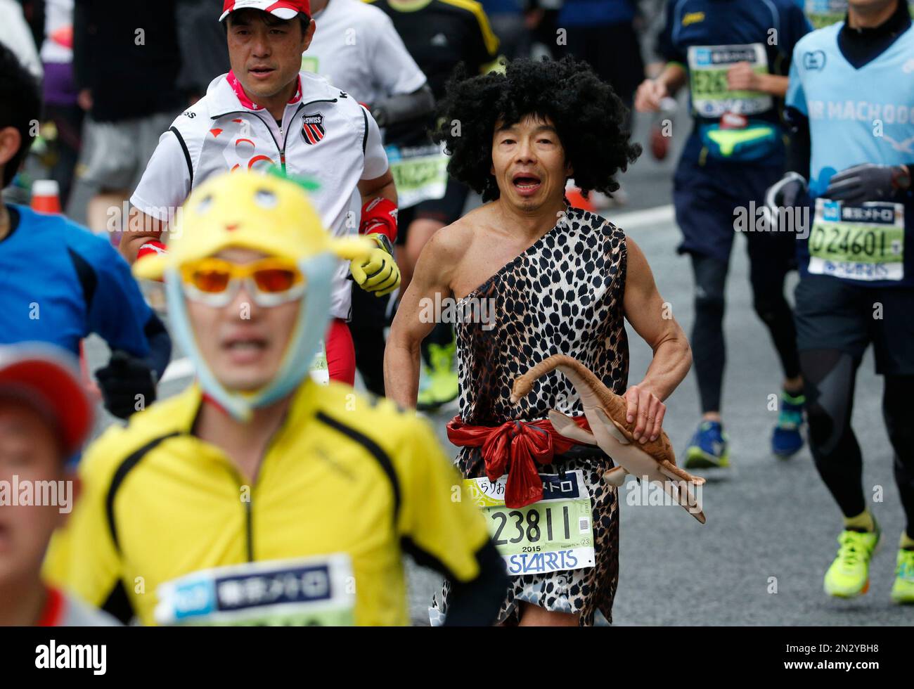 A runner dressed as prehistoric caveman costume races during the Tokyo ...