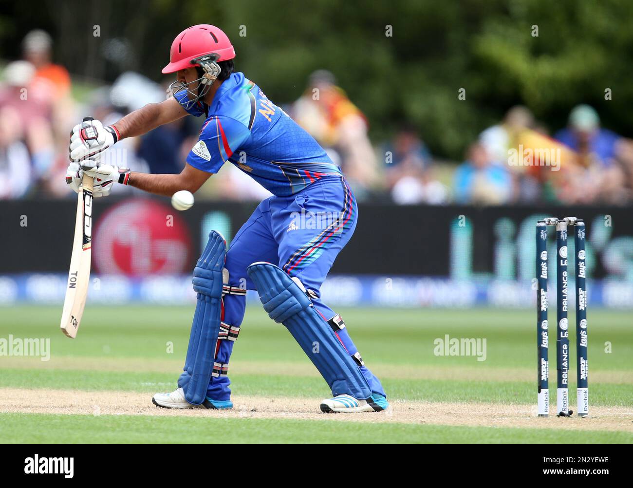 Afghanistan’s Najib Zadran plays and misses at a ball during their ...