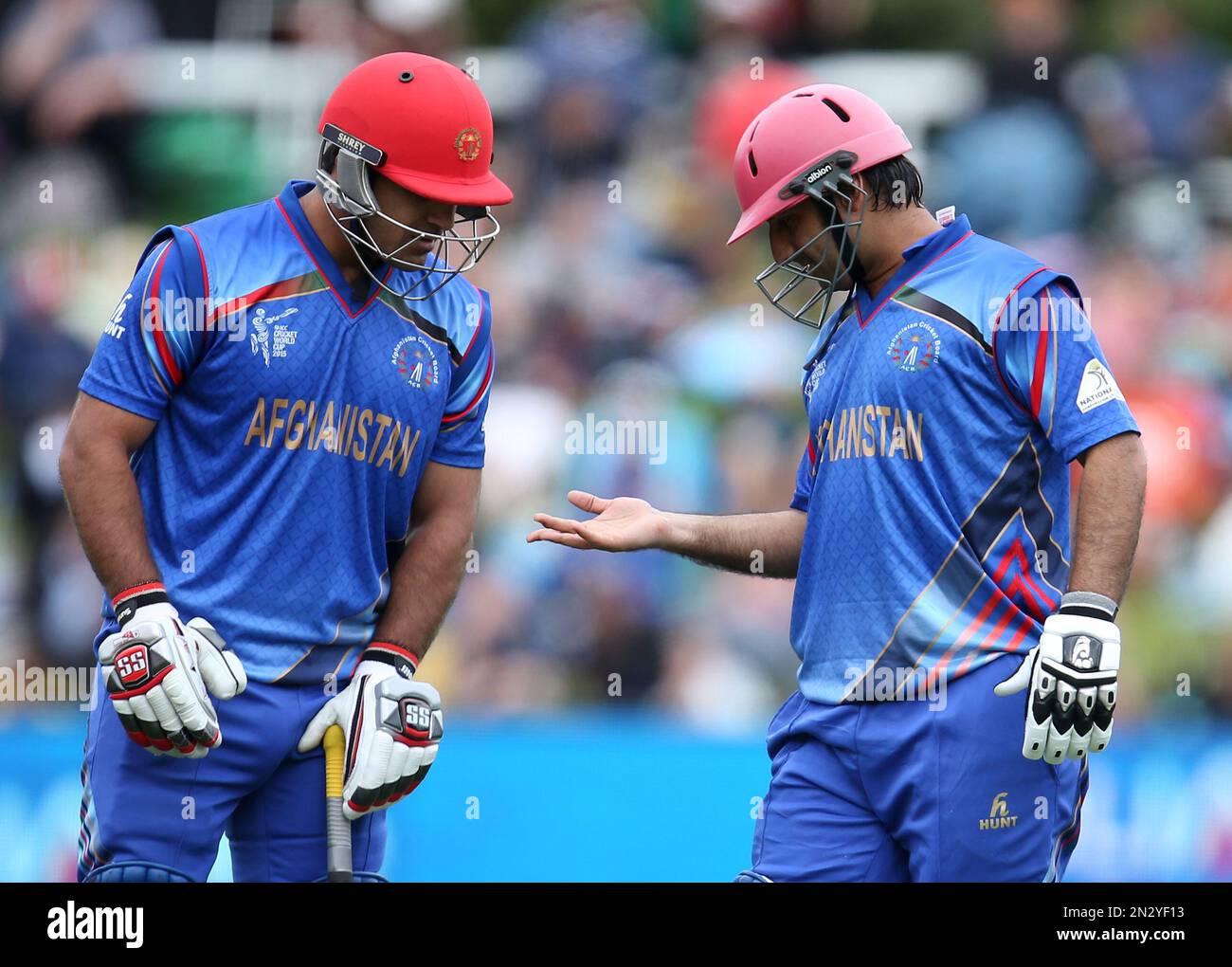 Afghanistan’s Asghar Stanikzai, right, looks at his hand after he was ...