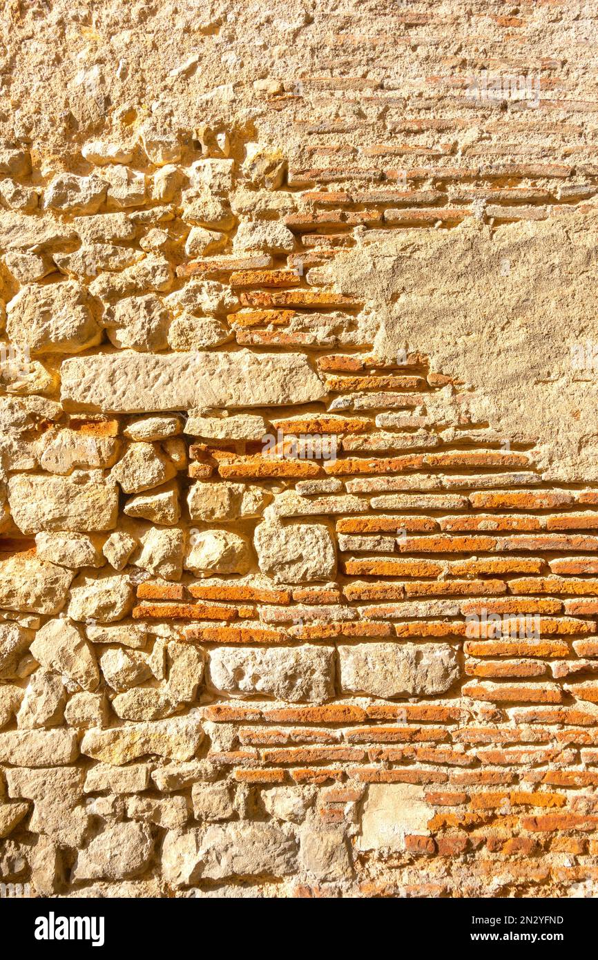 Detail of house wall made from old narrow bricks and random stone - Le ...