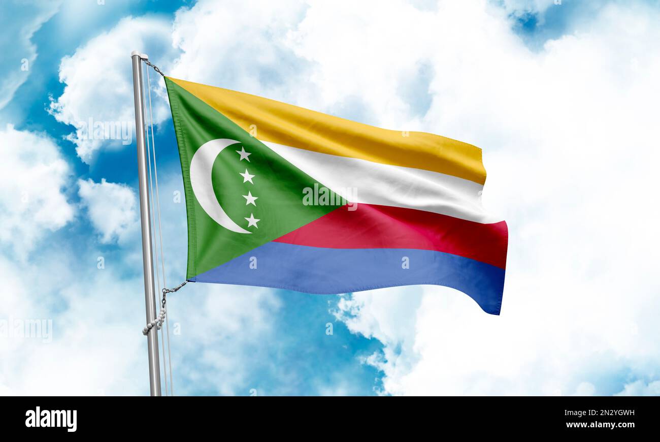 Comoros flag waving on sky background. 3D Rendering Stock Photo - Alamy