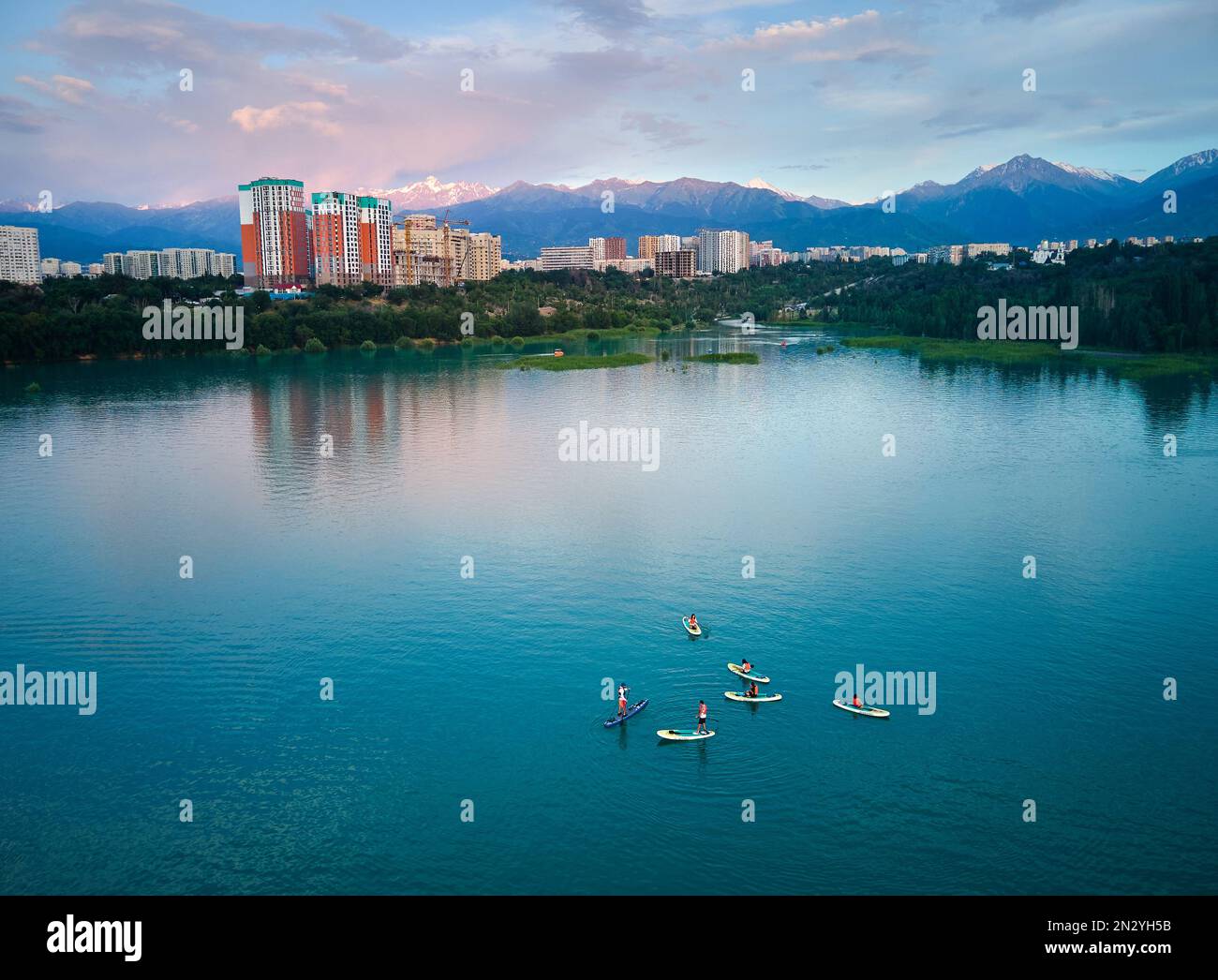 Top down aerial drone shot of group of people at stand up paddle boards ...