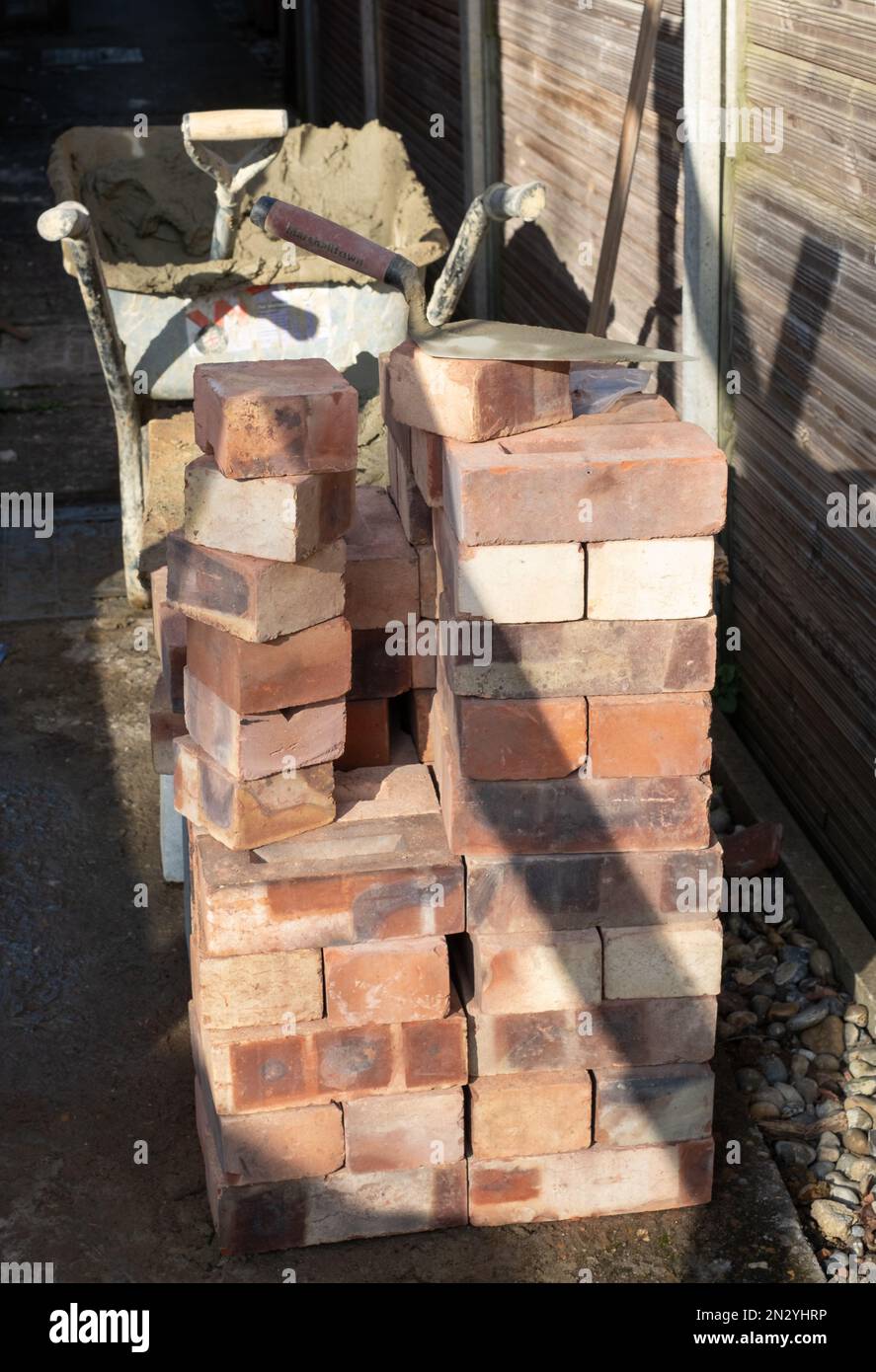 Building site: trowel, bricks and mortar for brickwork, part of a ...