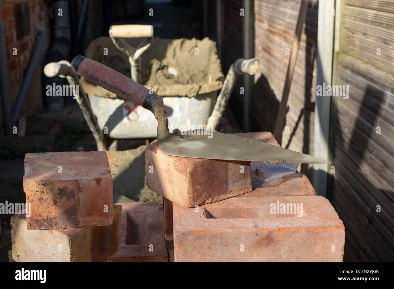 Building site: trowel, bricks and mortar for brickwork, part of a ...
