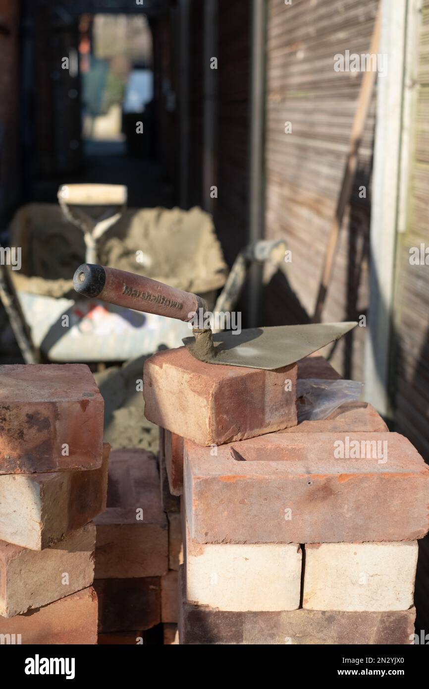 Building site: trowel, bricks and mortar for brickwork, part of a ...