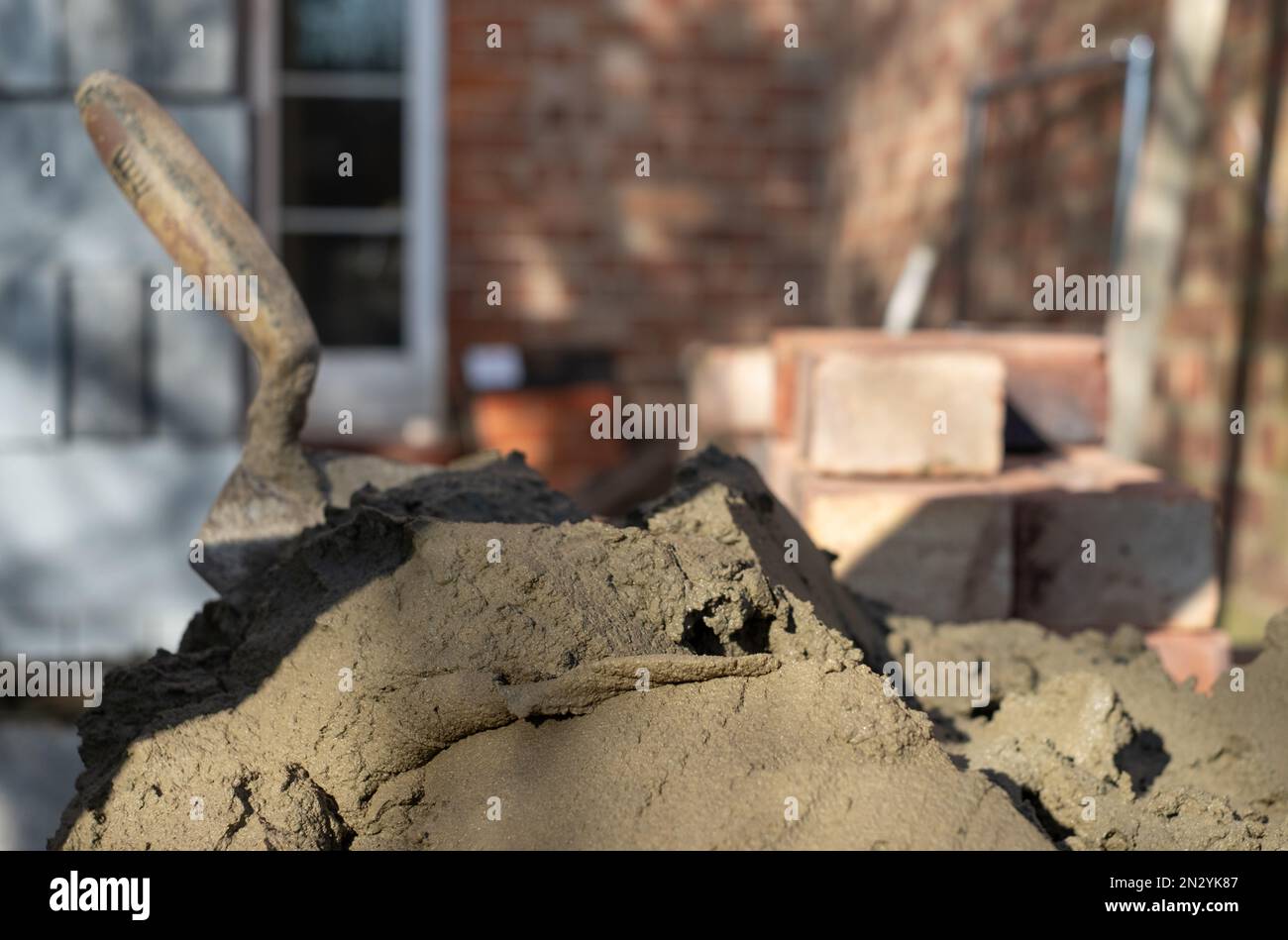 Building site: trowel, bricks and mortar for brickwork, part of a ...