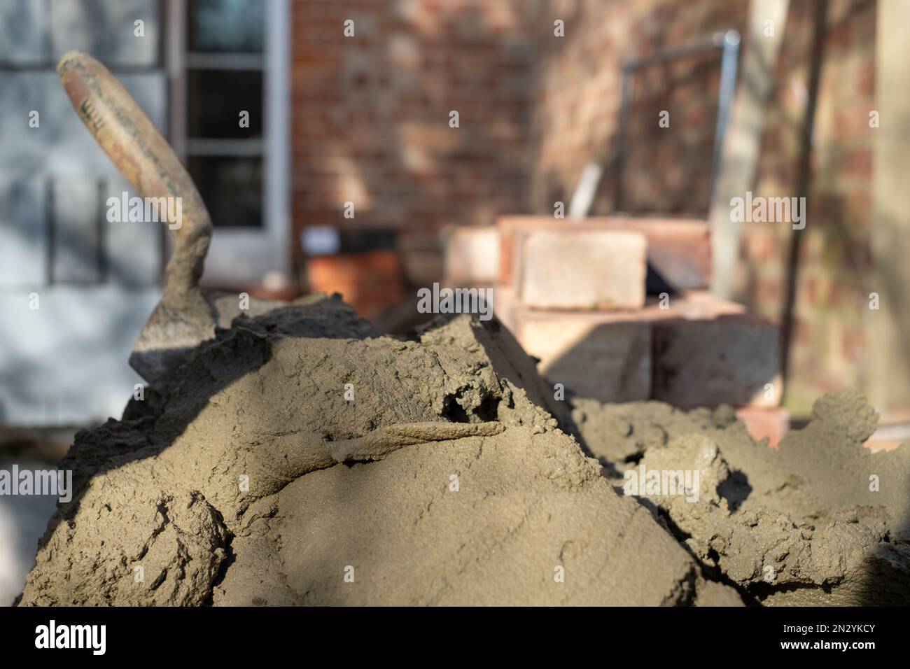 Building site: trowel, bricks and mortar for brickwork, part of a ...