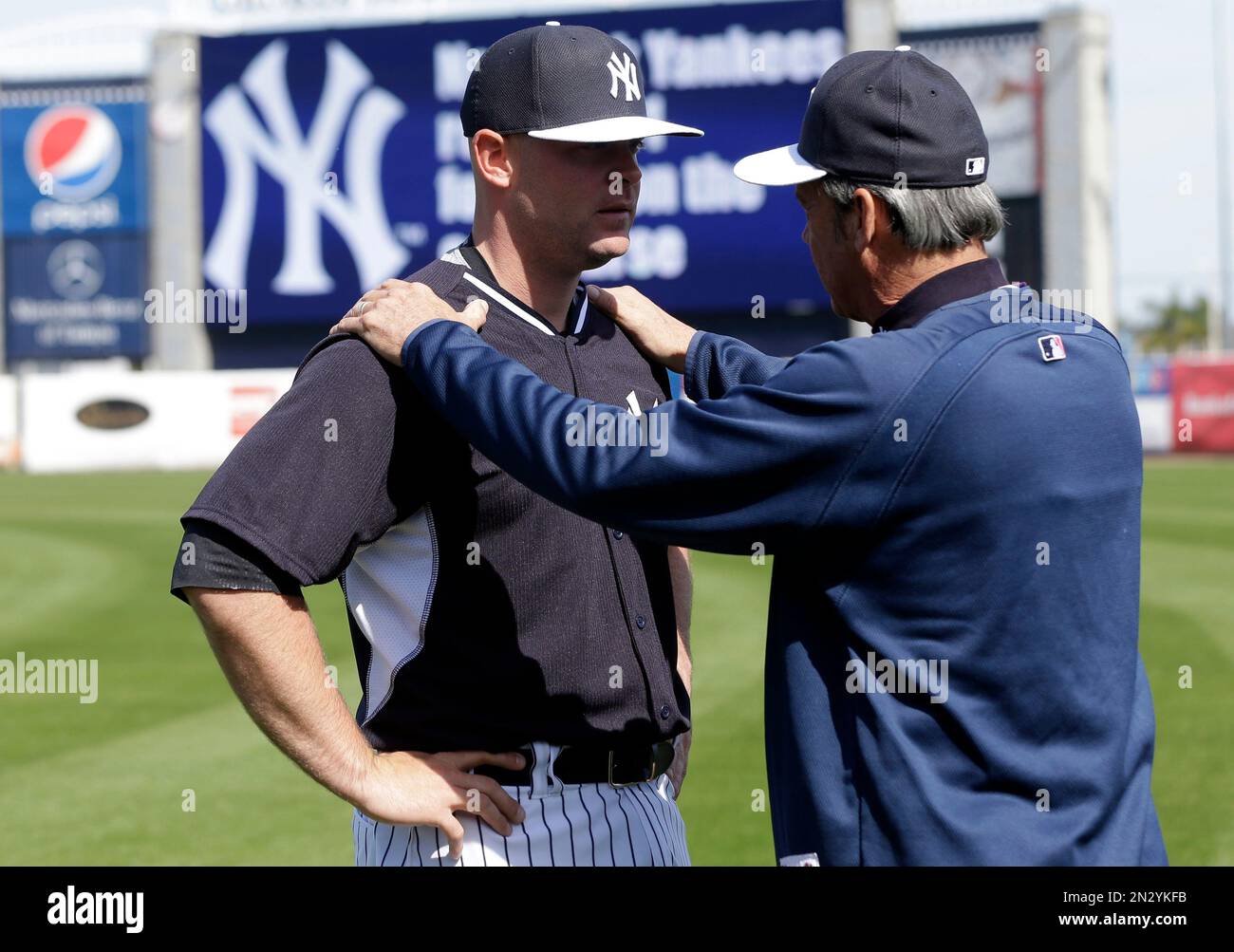 New York Yankees catcher Brian McCann, left, talks with guest instructor Ron Guidry, right ...