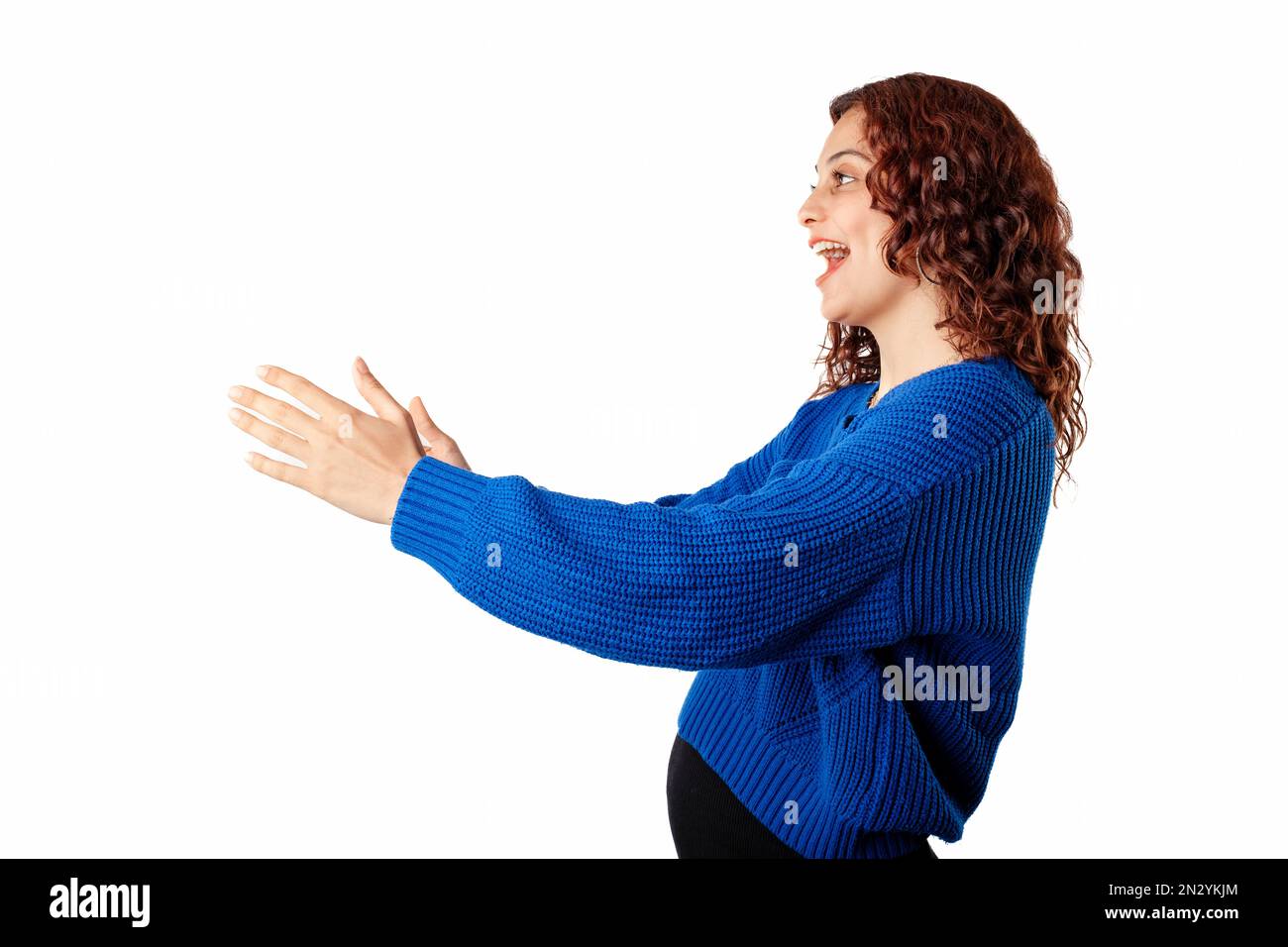 Side view of cheerful woman standing isolated over white background ...