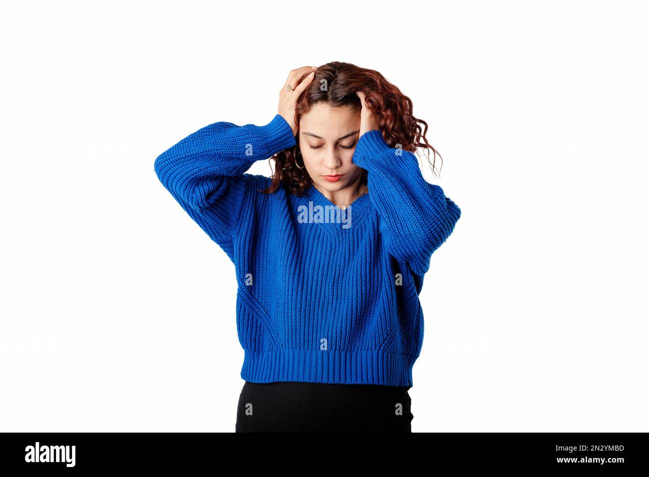 Portrait of young woman wearing sweater isolated over white background ...