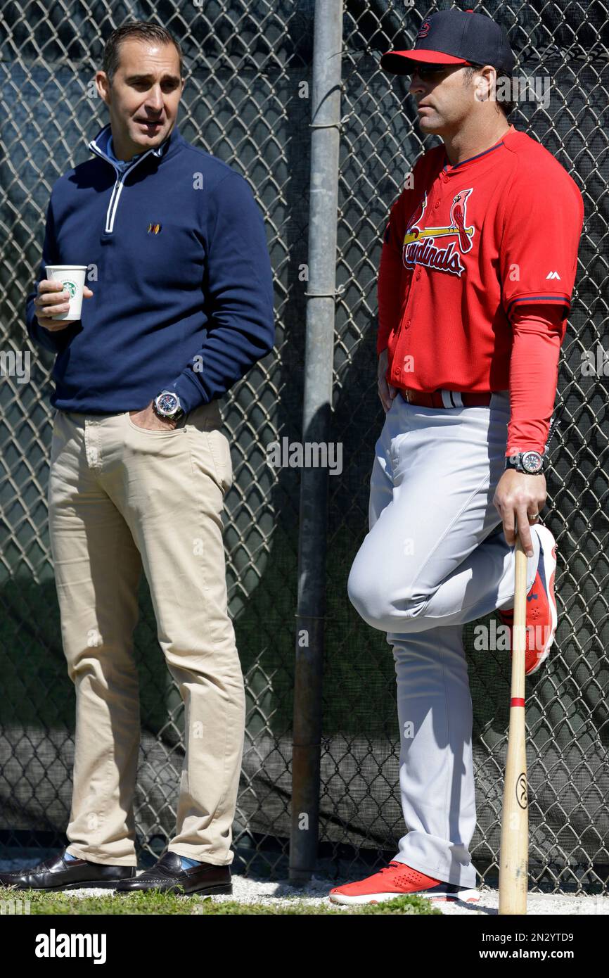 St. Louis Cardinals manager Mike Matheny, right, leans against a fence ...