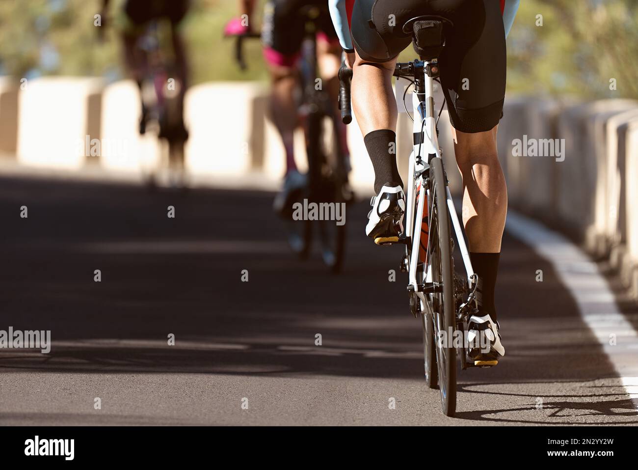 Cycling competition, cyclist athletes riding a race, climbing up a hill ...