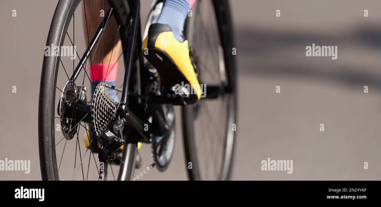 Racing bike detail on gear wheels and feet Stock Photo - Alamy