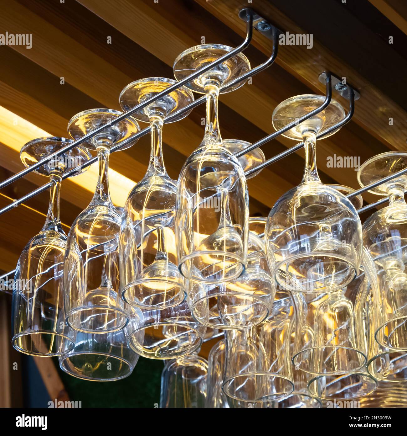 clean wine glasses hang over the bar. Glass, utensils, objects Stock ...