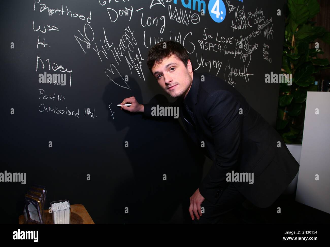 EXCLUSIVE - Josh Hutcherson signs the chalk wall during unite4:good and ...