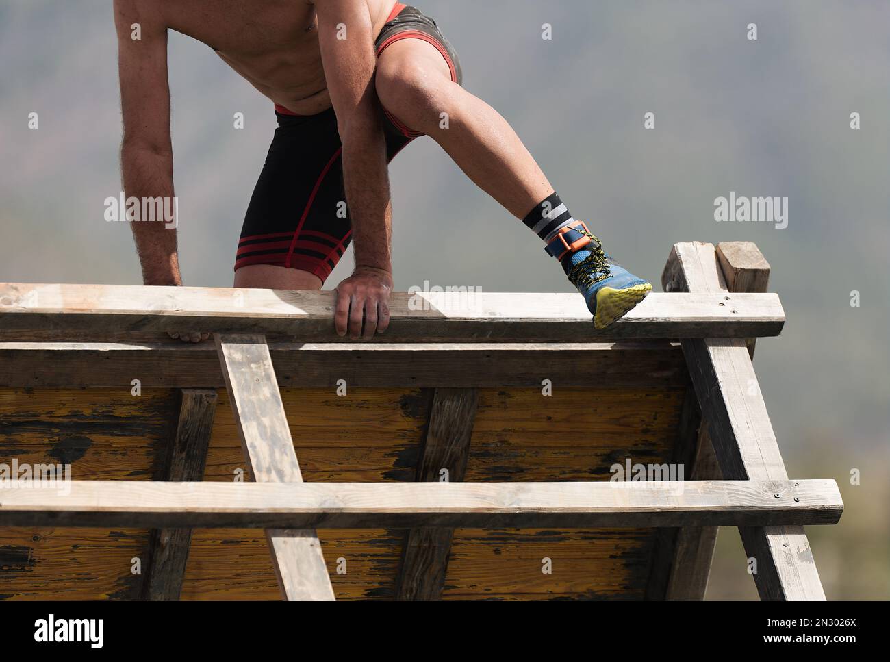 Man climbing over wall hi-res stock photography and images - Alamy