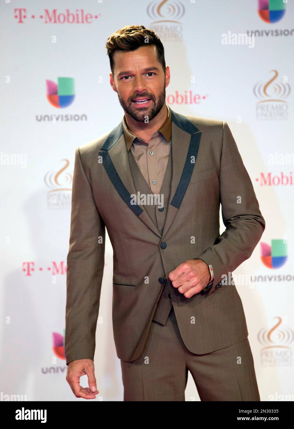Puerto Rican singer Ricky Martin poses for photographers as he arrives ...