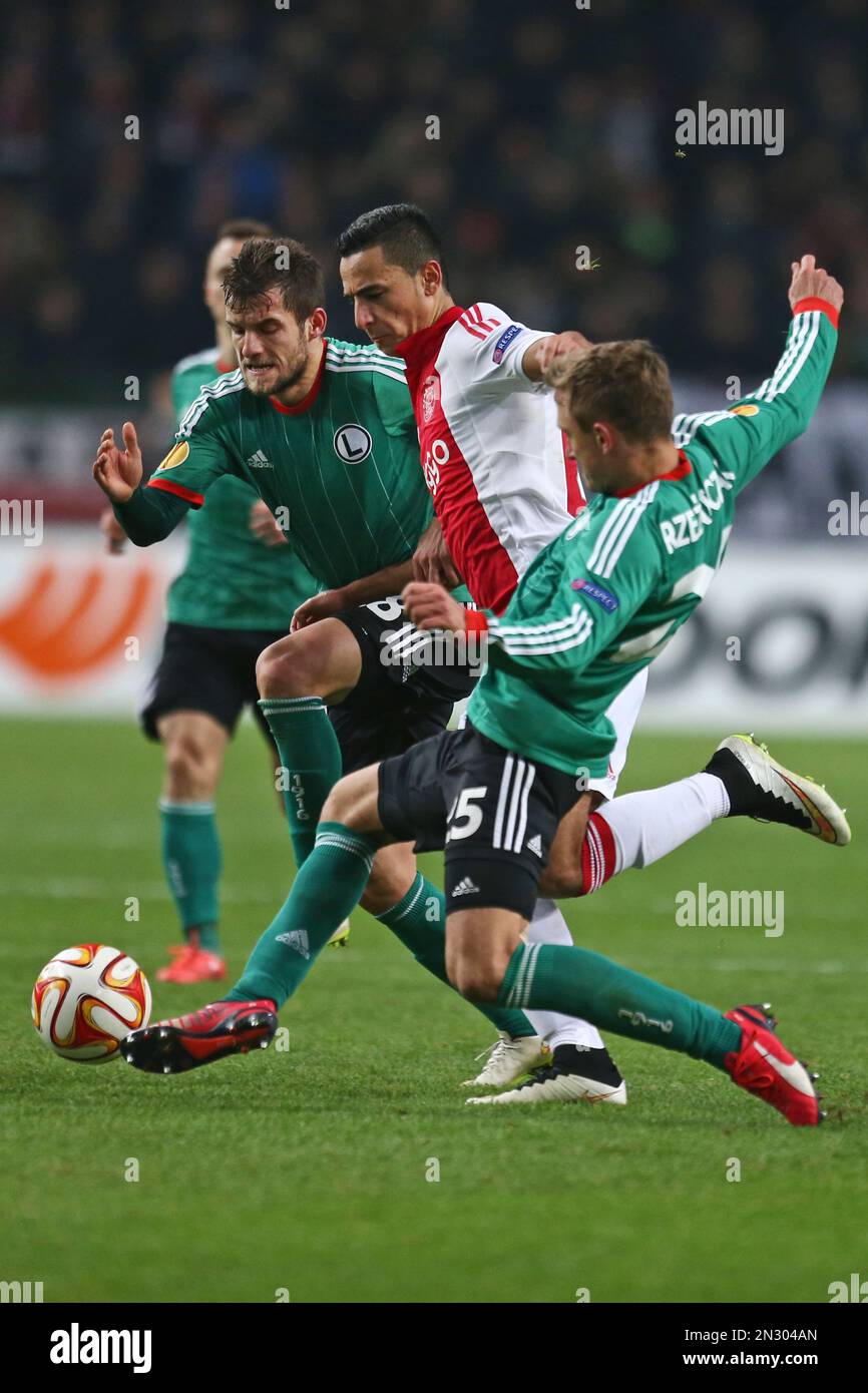 Legia's Lukasz Broz, left, and Legia's Jakub Rzezniczak, right, block ...
