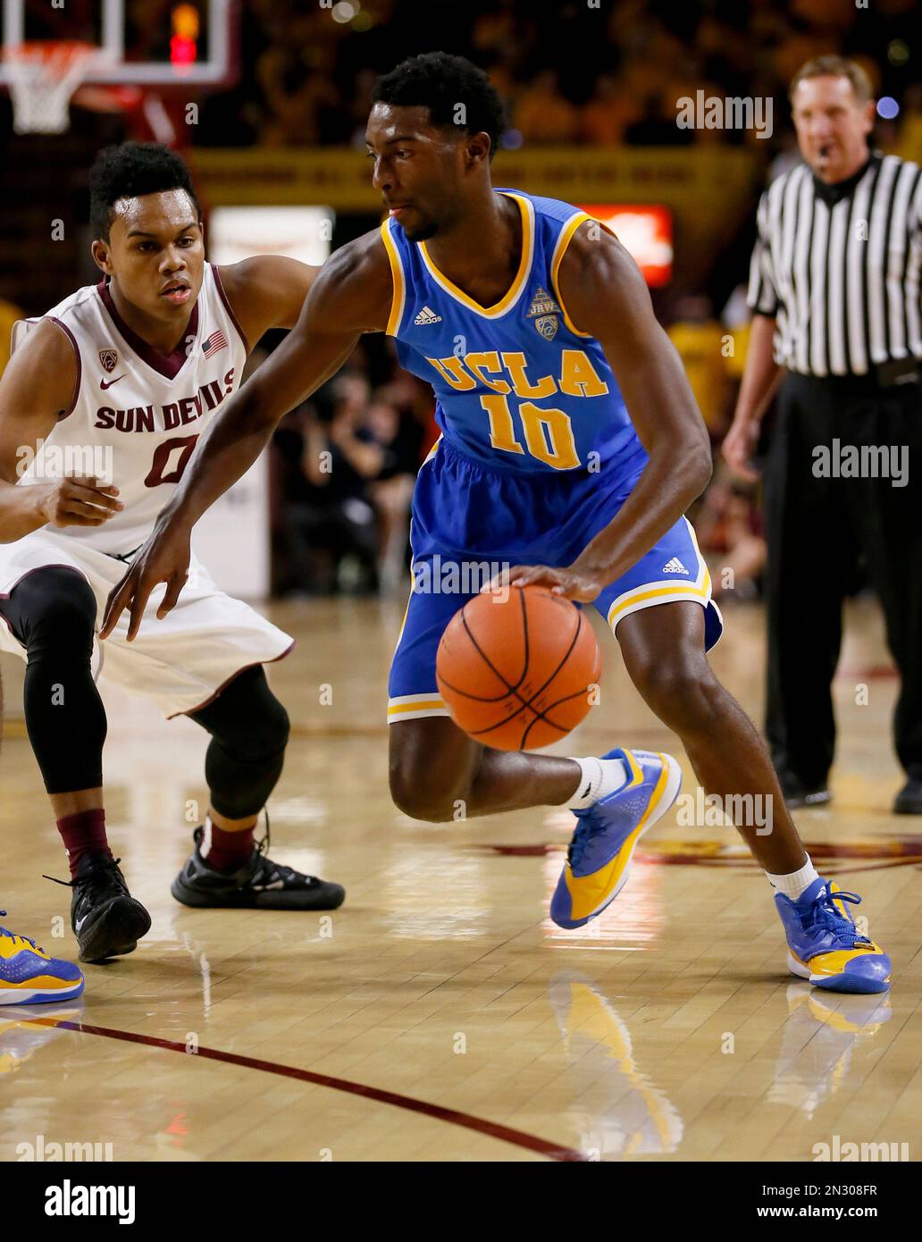 UCLA's Isaac Hamilton (10) drives against Arizona State's Tra Holder (0 ...