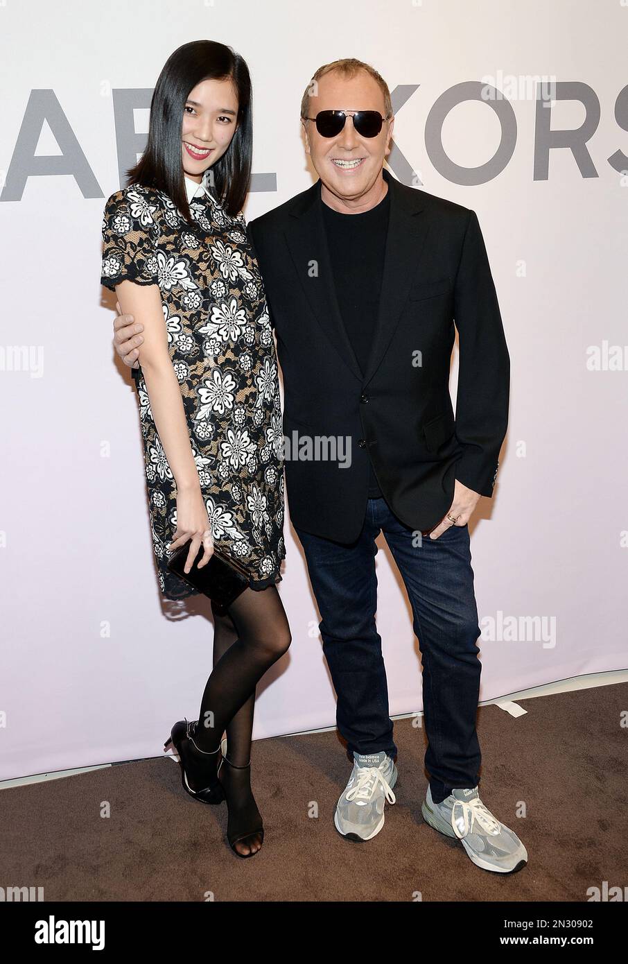 Japanese model Tao Okamoto, left, and designer Michael Kors attend the ...