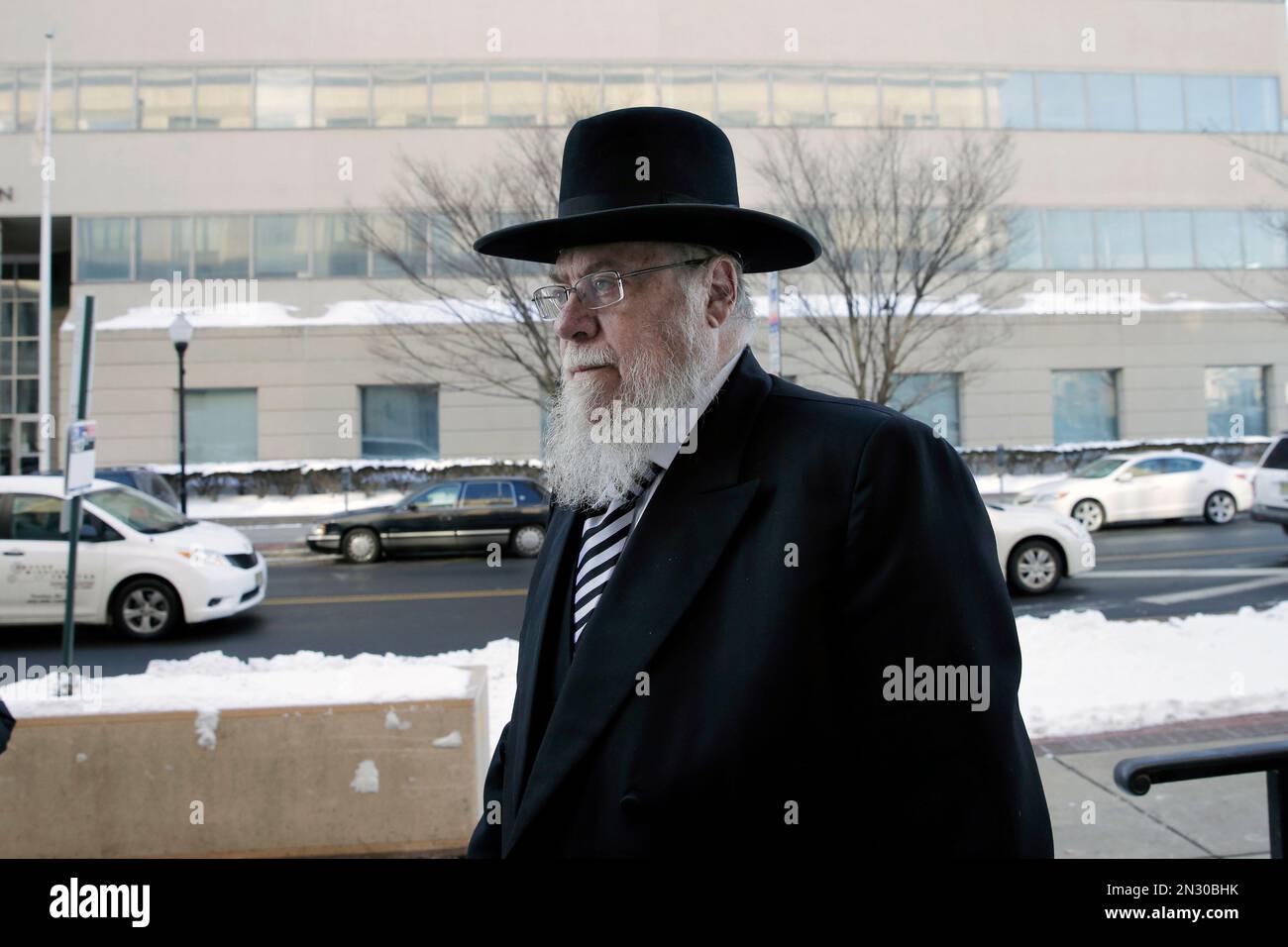 Rabbi Mendel Epstein, right, arrives for his trial at federal court in ...