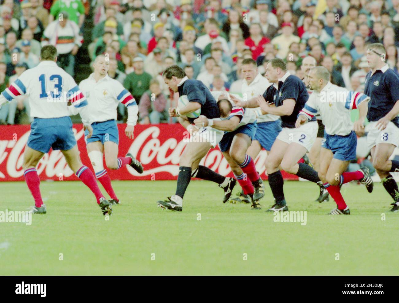 Scottish player Iain Morrison, no.7, is stopped by French players ...