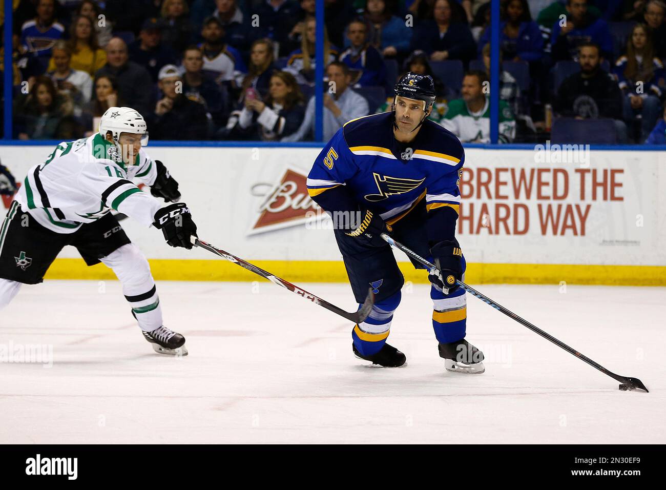 St. Louis Blues' Barret Jackman skates with the puck as he is defended ...