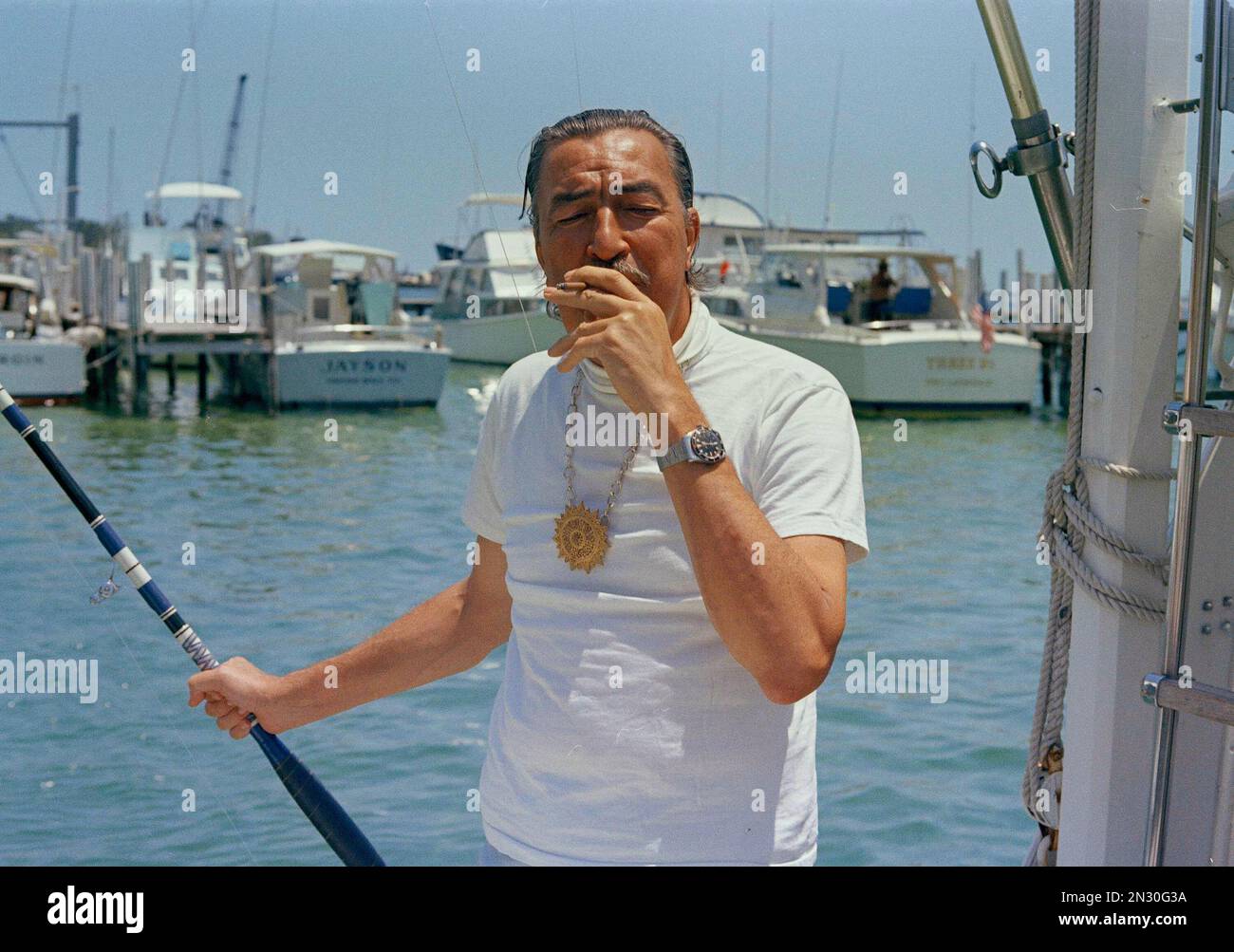Rep. Adam Clayton Powell Jr. is pictured having a smoke while fishing ...
