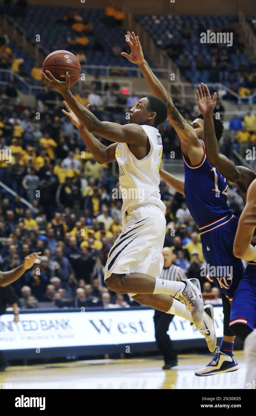 West Virginia guard Juwan Staten (3) drives past Kansas guard Kelly ...