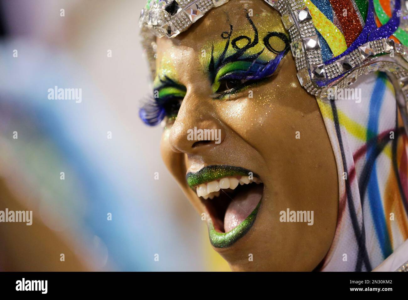 A performer from the Portela samba school sings out as she parades in ...
