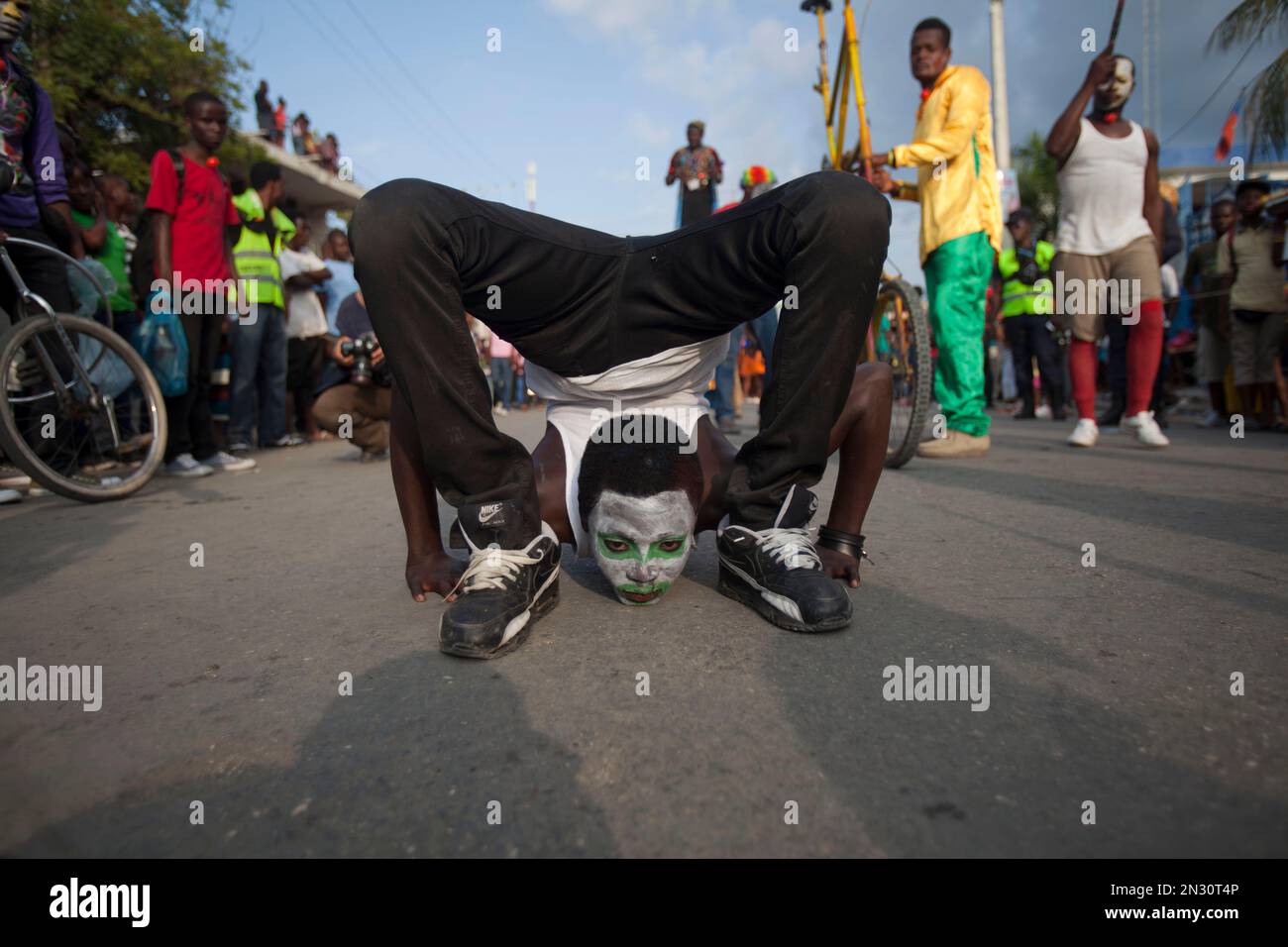 A mime performs a contortion backbend in a street parade, that kicked ...
