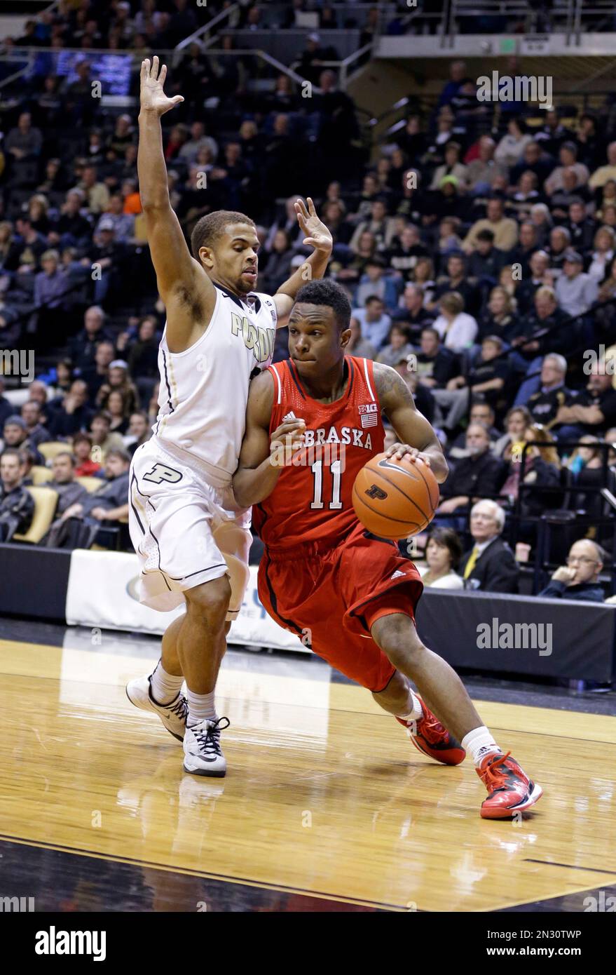 Nebraska guard Tarin Smith (11) drives under Purdue guard P.J. Thompson ...